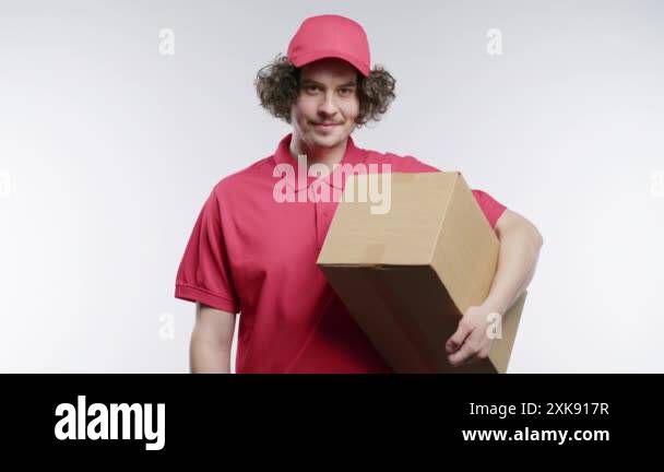 Friendly postman with parcel box showing yes signal, nods head, approve ...