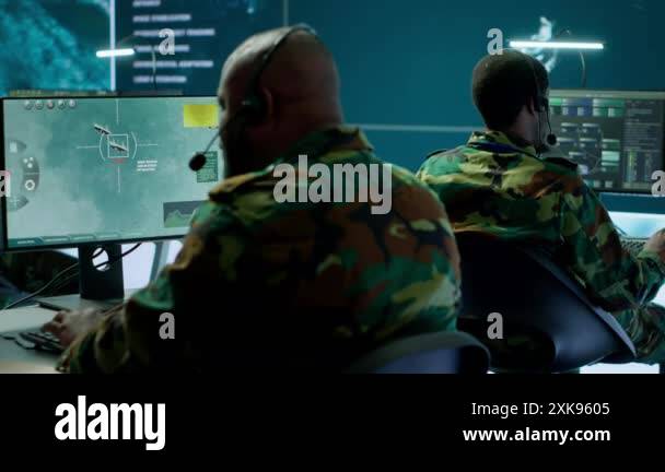 Government intelligence officers in control room manage surveillance ...