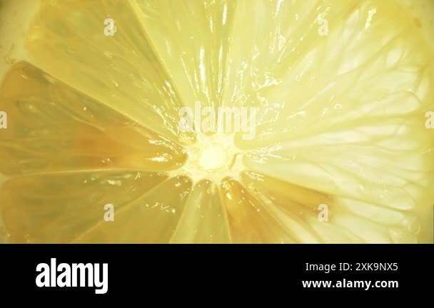 The macro photography of a sliced fresh lemon with vibrant yellow color ...