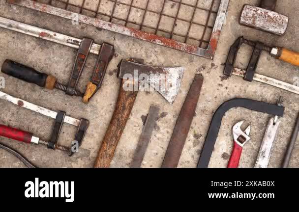 Old construction tools laid out on a concrete background, top view ...