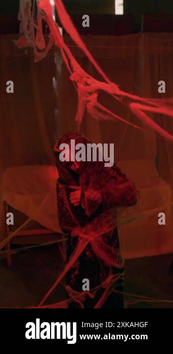 Beautiful girl with pale skin wearing black lace dress in spider web ...