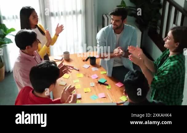 Top down view of business team clapping hands to celebrate successful ...