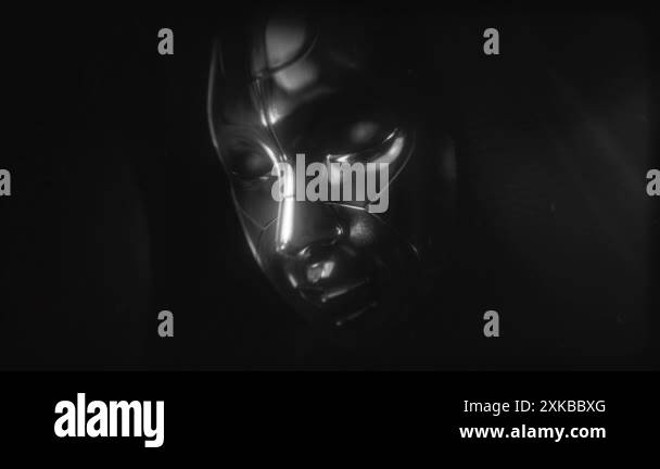 A stylised black and white sequence of a masked entity in the dark ...