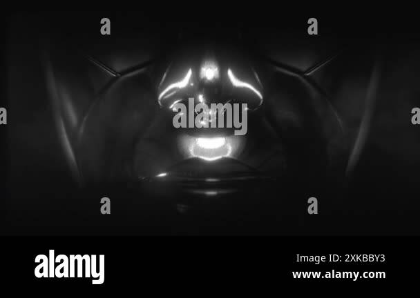 A stylised black and white sequence of a masked entity in the dark ...