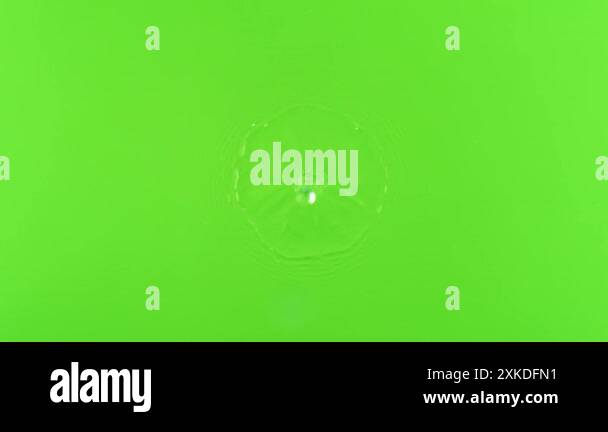 Slow motion of splashing water drop on green screen background , filmed ...