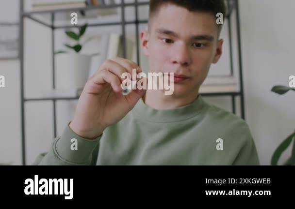 Medium close-up POV of deaf teenage Caucasian boy with hearing ...