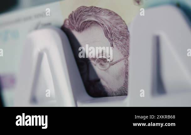 Close up of money counting machine counting thousand hryvnia banknotes ...