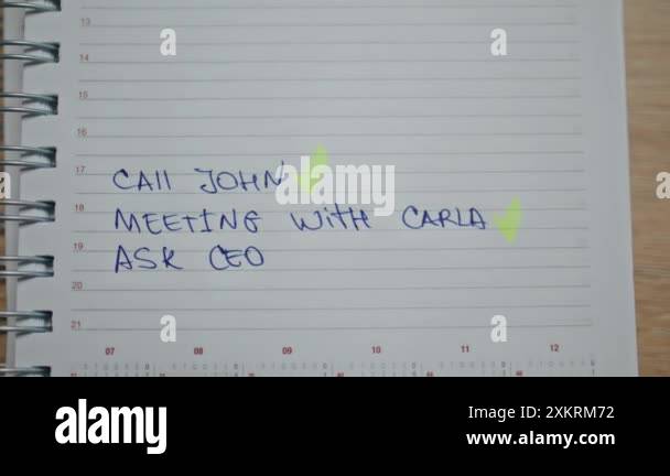 Hand marking completed tasks at table workplace closeup. Office worker ...