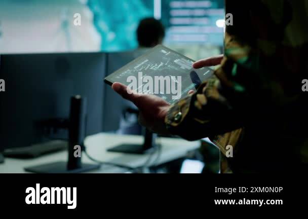 Military officer leads cybersecurity operations in a high tech ...