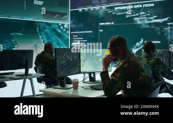 Soldiers in a state of the art military control room collaborate on ...