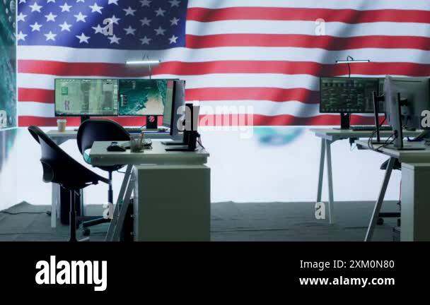 Empty military control center with a big screen shows the American flag ...