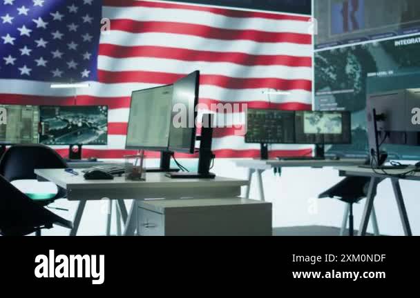 Empty military control center with a big screen shows the American flag ...