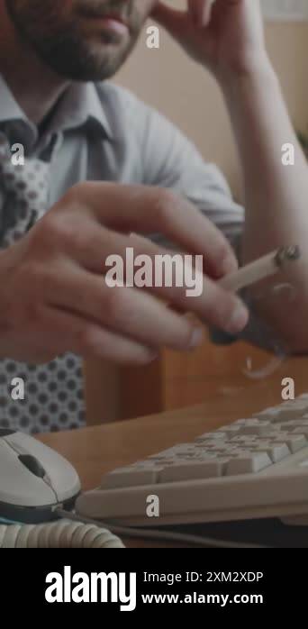 Vertical side tilt shot of tired bearded Caucasian employee in shirt ...