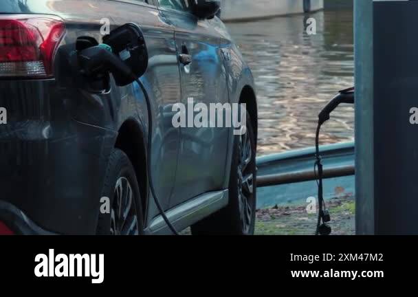 Charging EV in parking lot with renewable energy sources. An electric ...