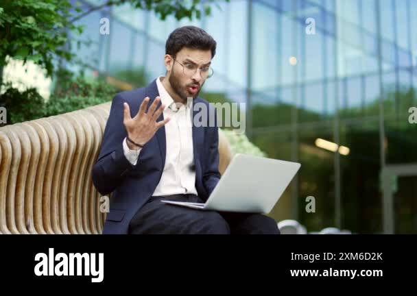 Disappointed businessman in a suit read bad news on laptop sitting on ...