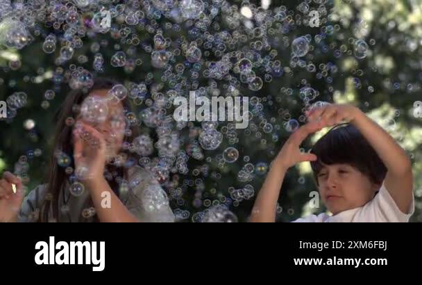 Kids reaching out to touch bubbles in slow motion at 800 fps, their ...