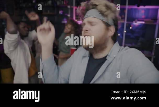 Cheerful young man vlogger recording funny video from party dancing ...