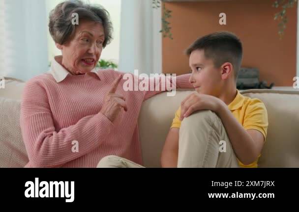 Caucasian grandmother explaining punishing spoiled grandson strict ...