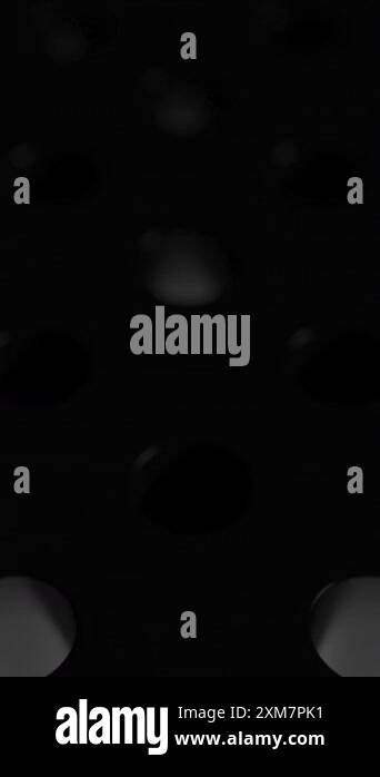 White glowing spheres jump from one hole to another. Dark reflective ...
