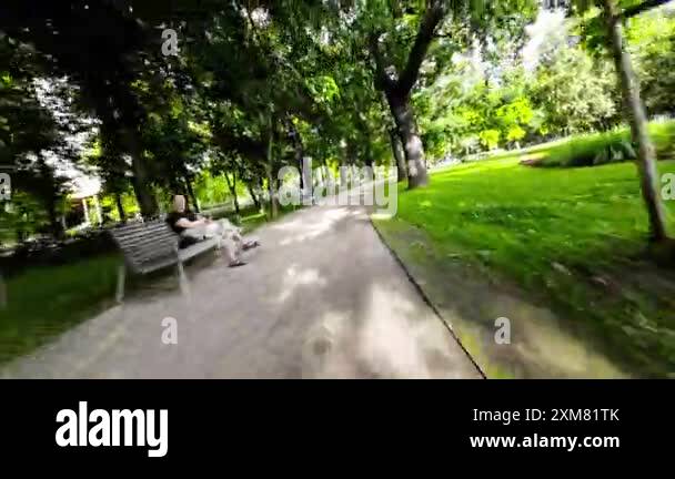 A calming walk through a lush green park in Opole, Poland. The park is ...