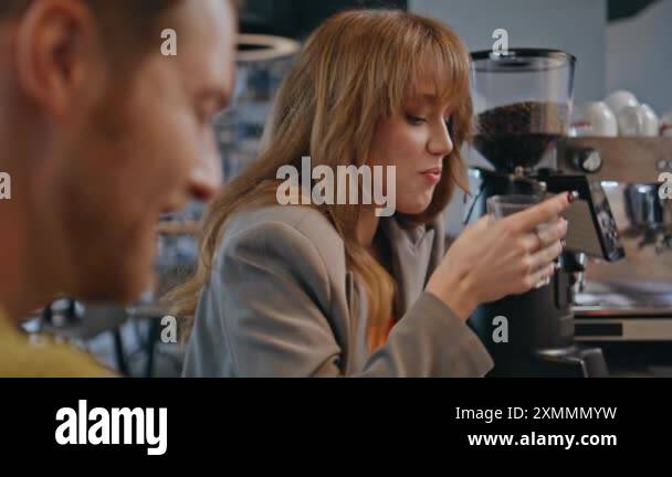 Cheerful girl enjoying coffee break at bar counter closeup. Happy couple laughing resting after ...