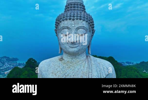 An impressive and serene Buddha statue stands tall, representing peace ...