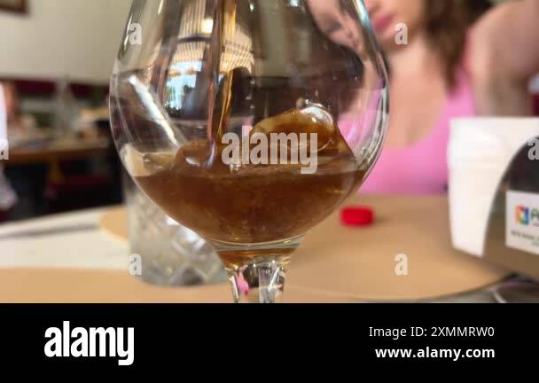 Pouring Cola with ice cubes. Cola with Ice and bubbles in glass. Soda closeup. Food background ...