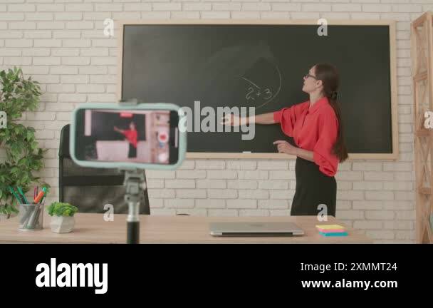 School teacher in class on video conference. Woman teacher in empty ...