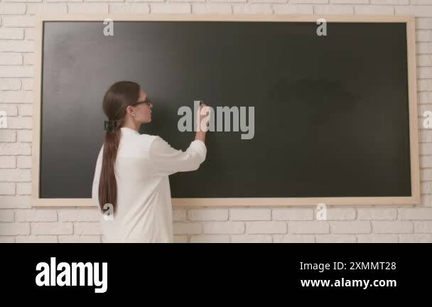 School teacher speaking to young people in class. Woman college teacher ...