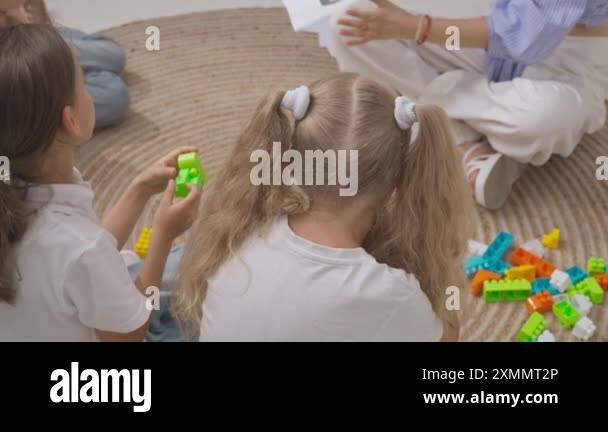 Group of kids visiting preschool classes. Young teacher and group of ...