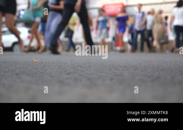 Low angle view of unrecognizable pedestrians crossing intersection in ...