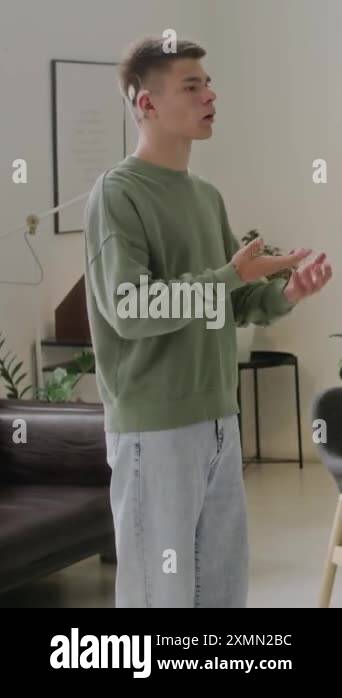 Medium full vertical shot of deaf teenage Caucasian boy with cochlear ...