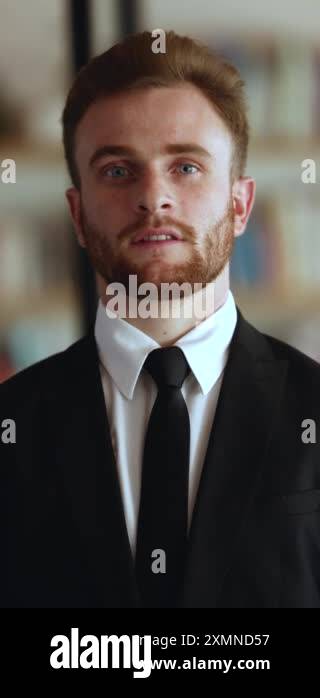 Thoughtful handsome young Caucasian businessman wearing formal suit and ...