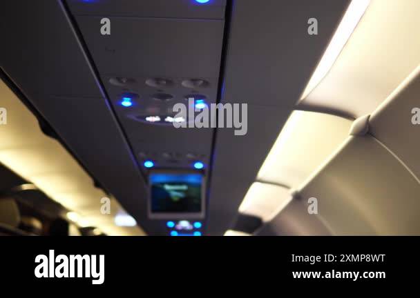 Aircraft cabin view displaying seating rows, overhead bins, and windows ...