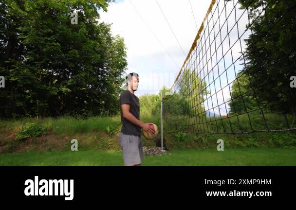 Young promising volleyball player trains the smashing technique from ...