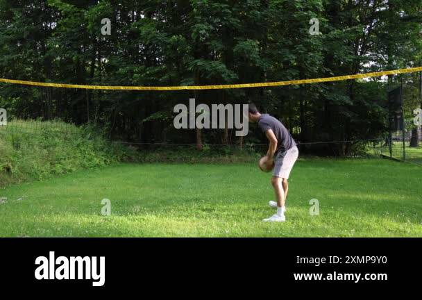 Young promising volleyball player trains the smashing technique from ...