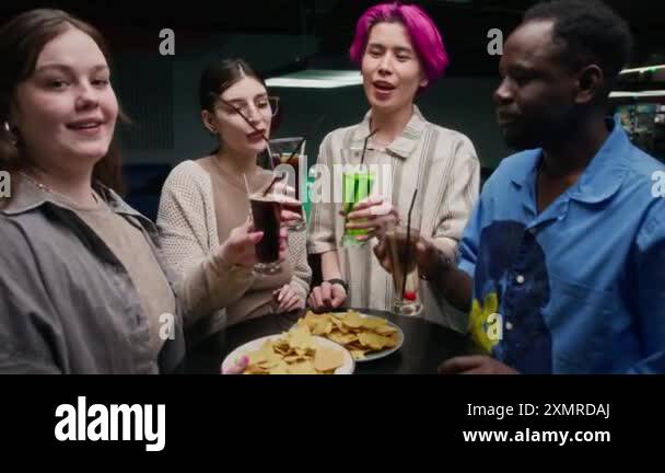 Medium slowmo portrait of diverse group of gen z friends cheering with ...