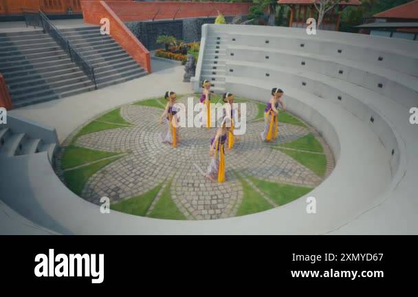 A group of dancers in traditional attire performing in an outdoor ...