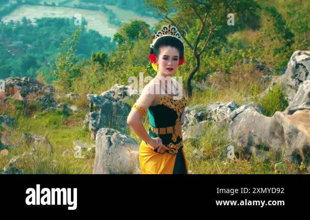 A woman in traditional attire poses confidently in a scenic outdoor ...