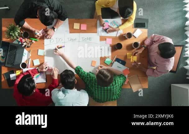 Top down aerial view of diverse business team making scrum task board ...