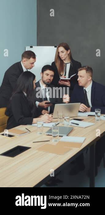 Vertical screen: Business team in meeting, discussing and planning at ...