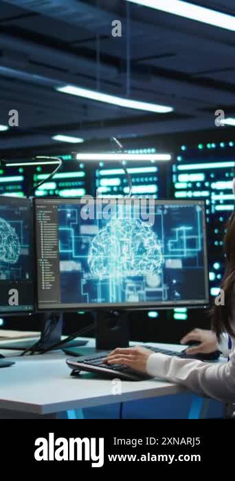 Vertical video Technicians coworkers using AI tech on computer to do checkup in server room ...