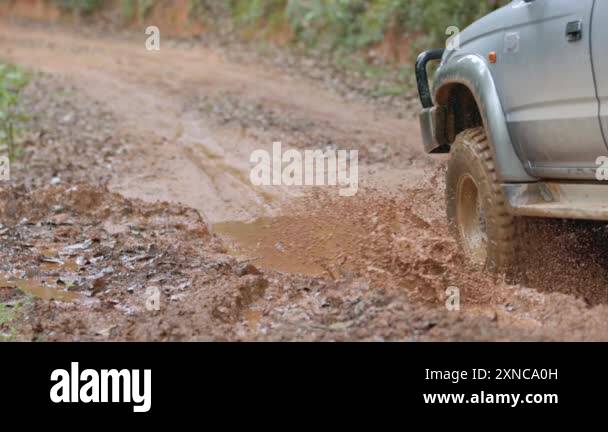 Cars running on off-road roads and splashing mud on natural paths. Off ...