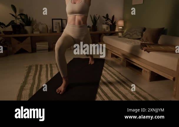 Tilt shot of slim Caucasian yogini in beige activewear standing in ...