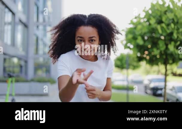Beautiful african american woman turning around and waving hands in ...