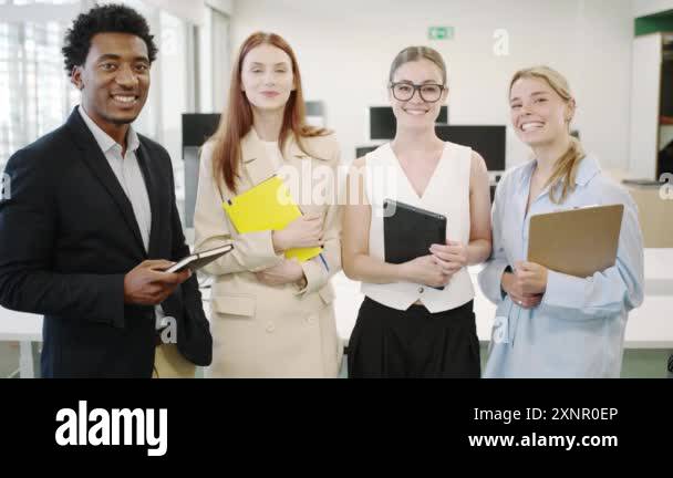 A diverse group of young professionals collaborate in a modern office ...