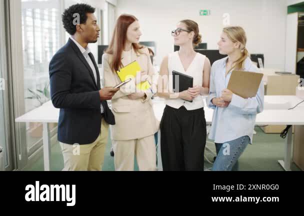 A diverse group of young professionals engaging in a discussion in a ...