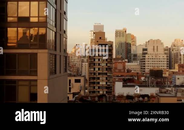 Cityscape with modern buildings and high rises at sunset, reflecting in ...