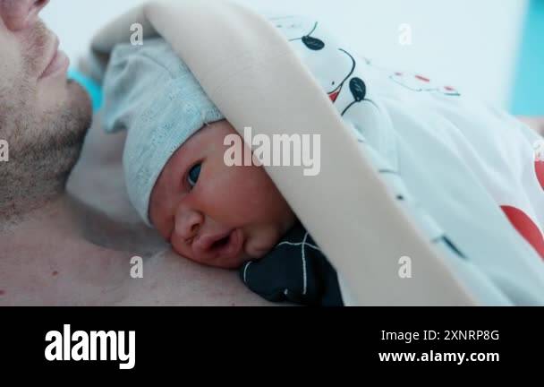 Caucasian bearded father holding his just born baby. Skin to skin ...