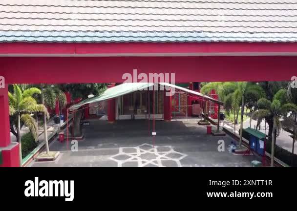A traditional Asian-style building with green tiled roofs and red ...